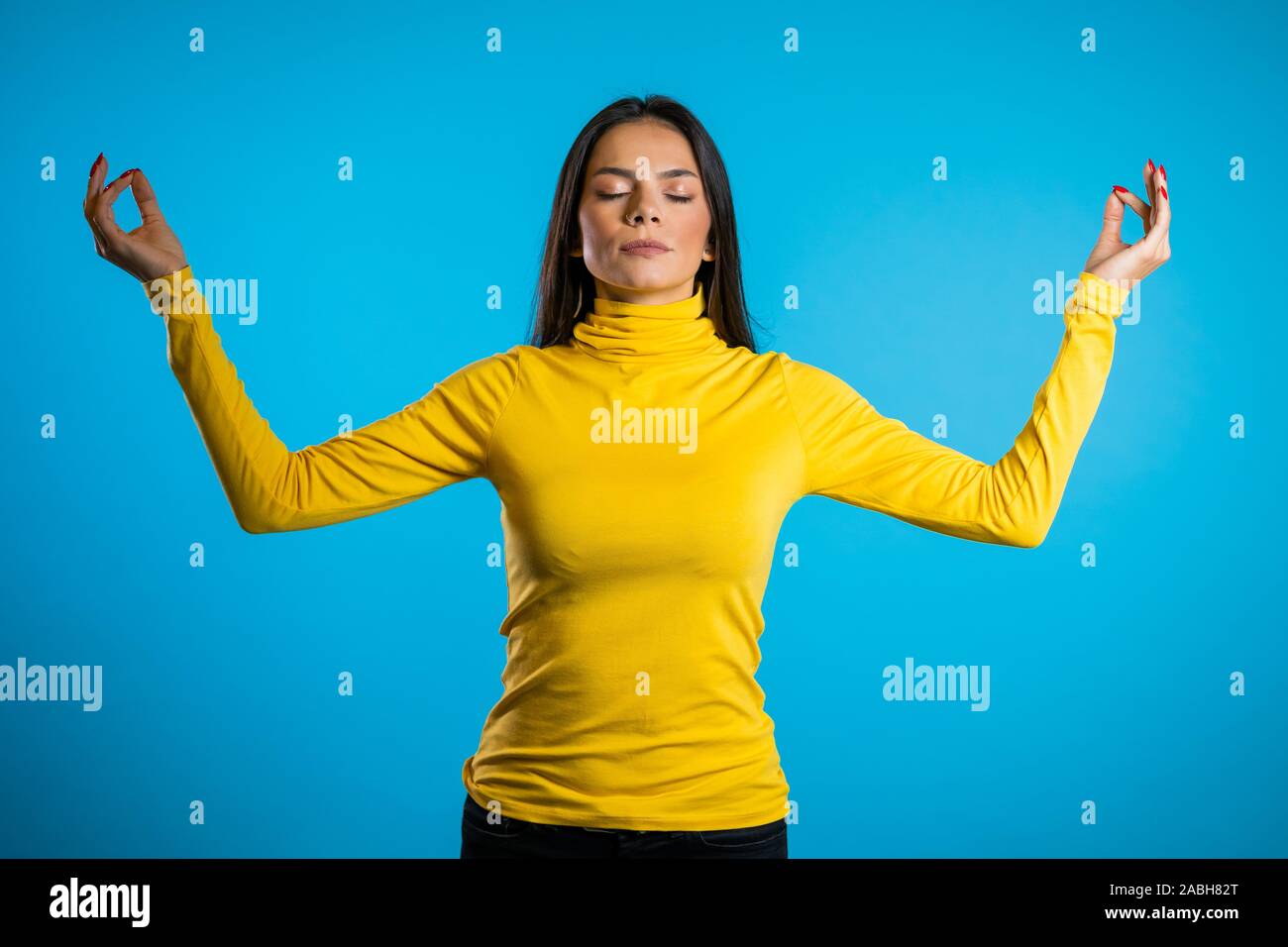Calm girl in yellow relaxing, meditating. Woman calms down, breathes ...