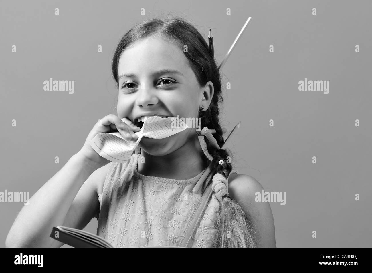 School girl with happy face isolated on blue background. Kid in pink ...