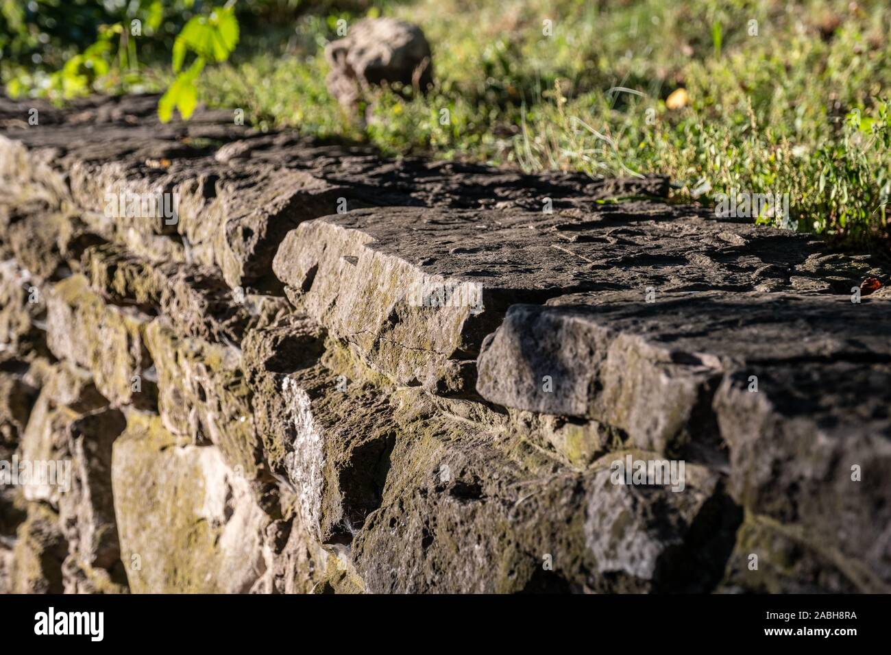 Fragment of an ancient stone wall in perspective. Historic defensive ...
