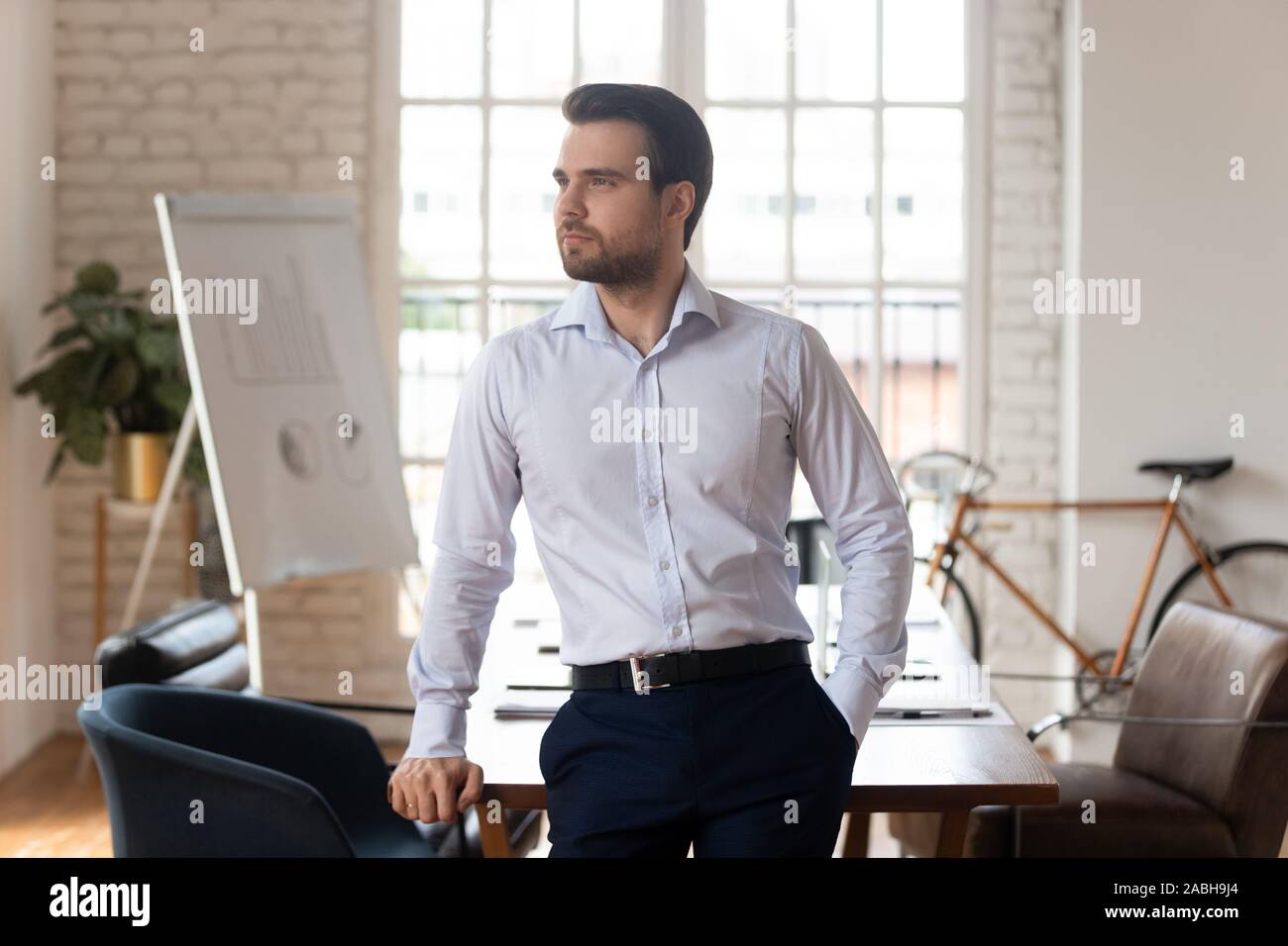 Confident successful male millennial company owner thinking of business ...