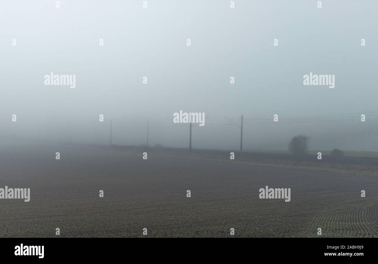 Railroad tracks covered by a dense mist in Baden Wurttemberg, Germany ...