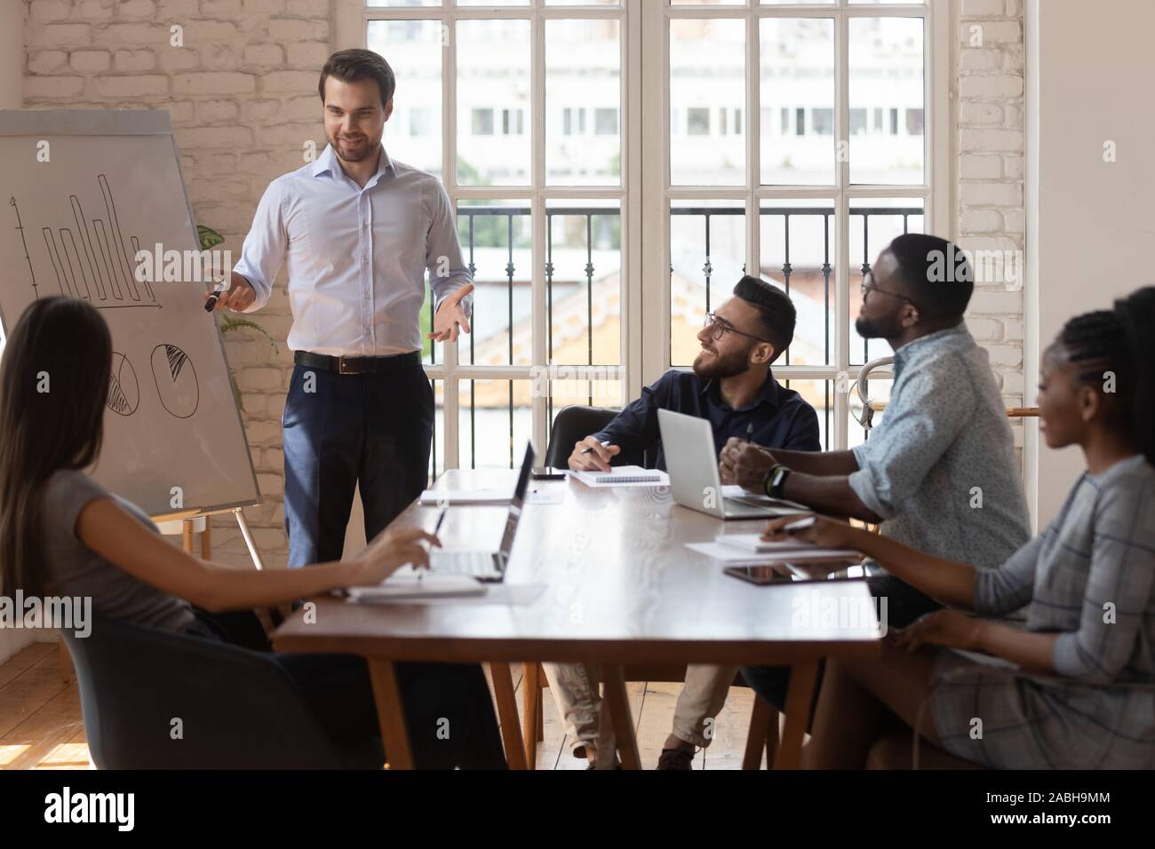 Happy confident team leader explaining company development strategy ...