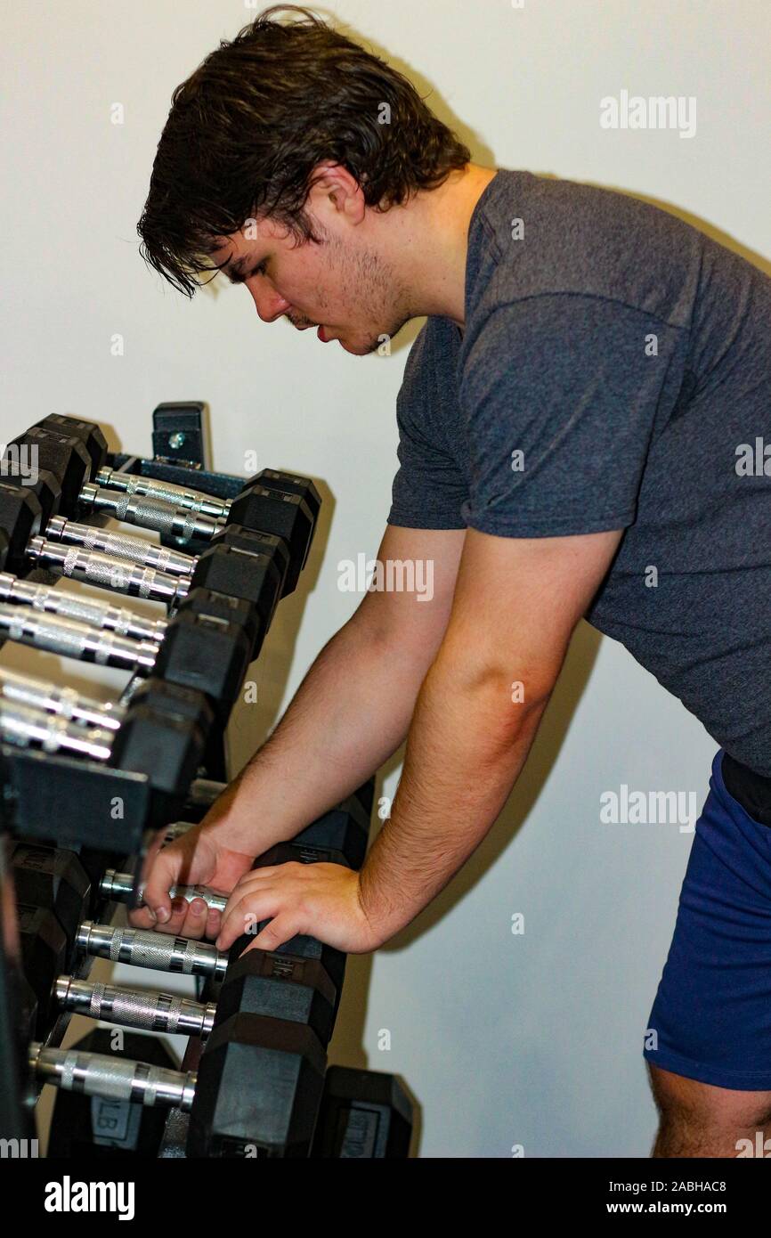 overweight young man exercising in fitness center Stock Photo - Alamy