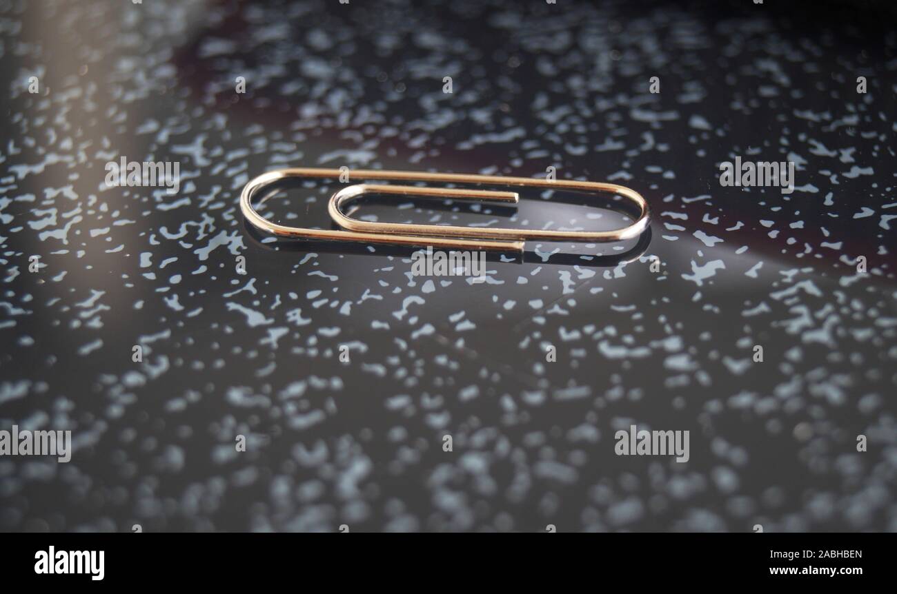 Colorful paperclip with a blue background Stock Photo - Alamy