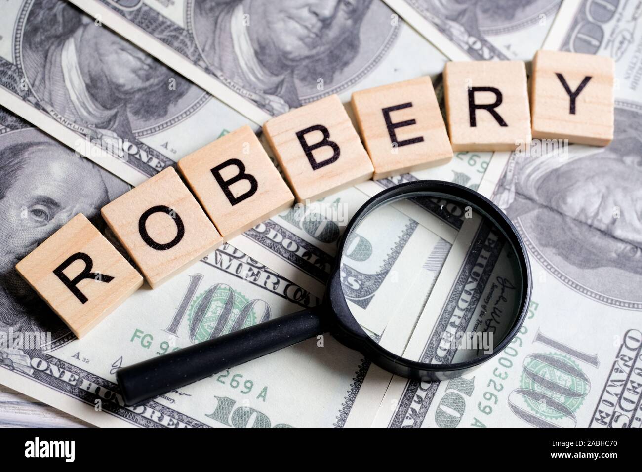 Word made of wooden letters - robbery, on a gray background with us ...