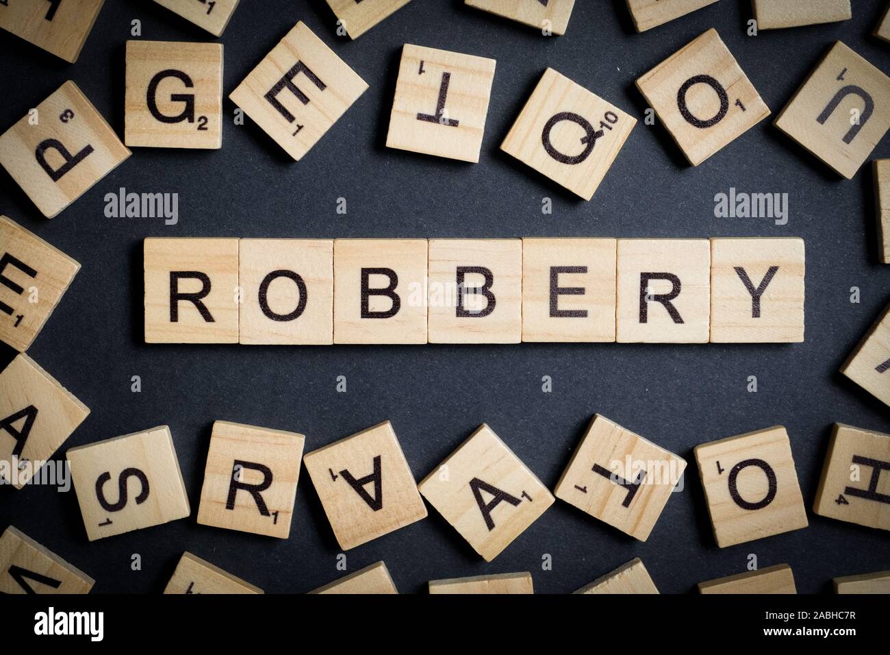Word made of wooden letters - robbery, on black background. The concept ...