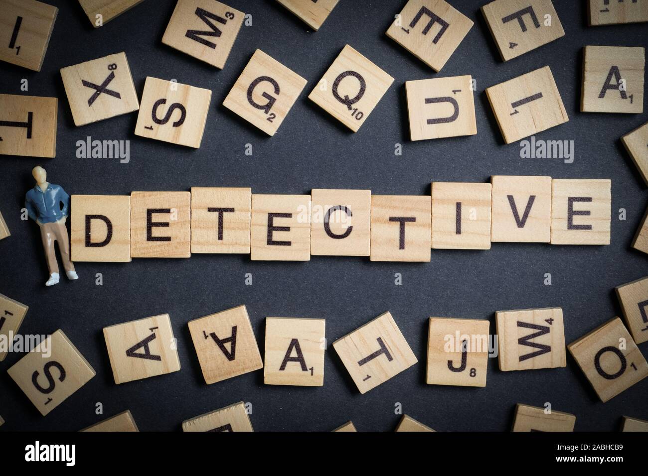 Word made of wooden letters - detective, on black background with ...