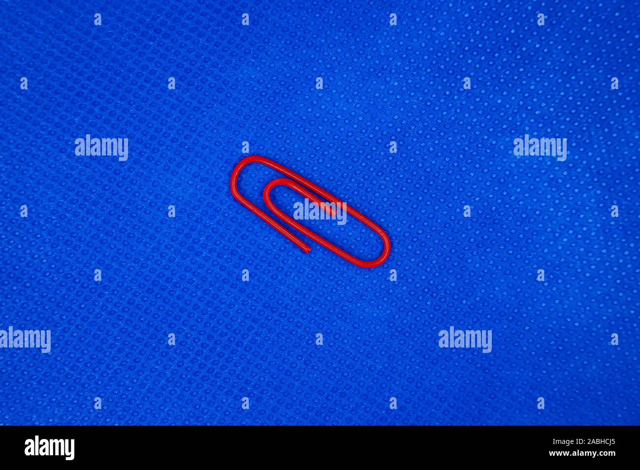 Colorful paperclip with a blue background Stock Photo - Alamy