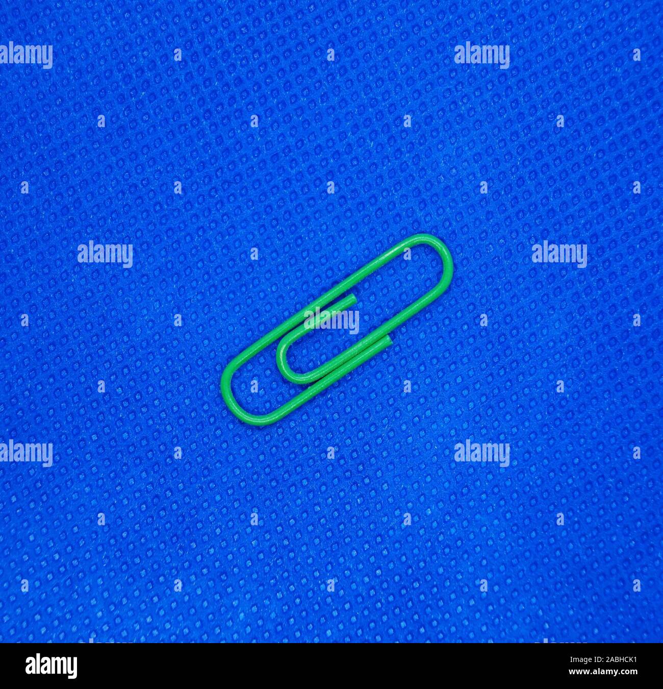 Colorful paperclip with a blue background Stock Photo - Alamy