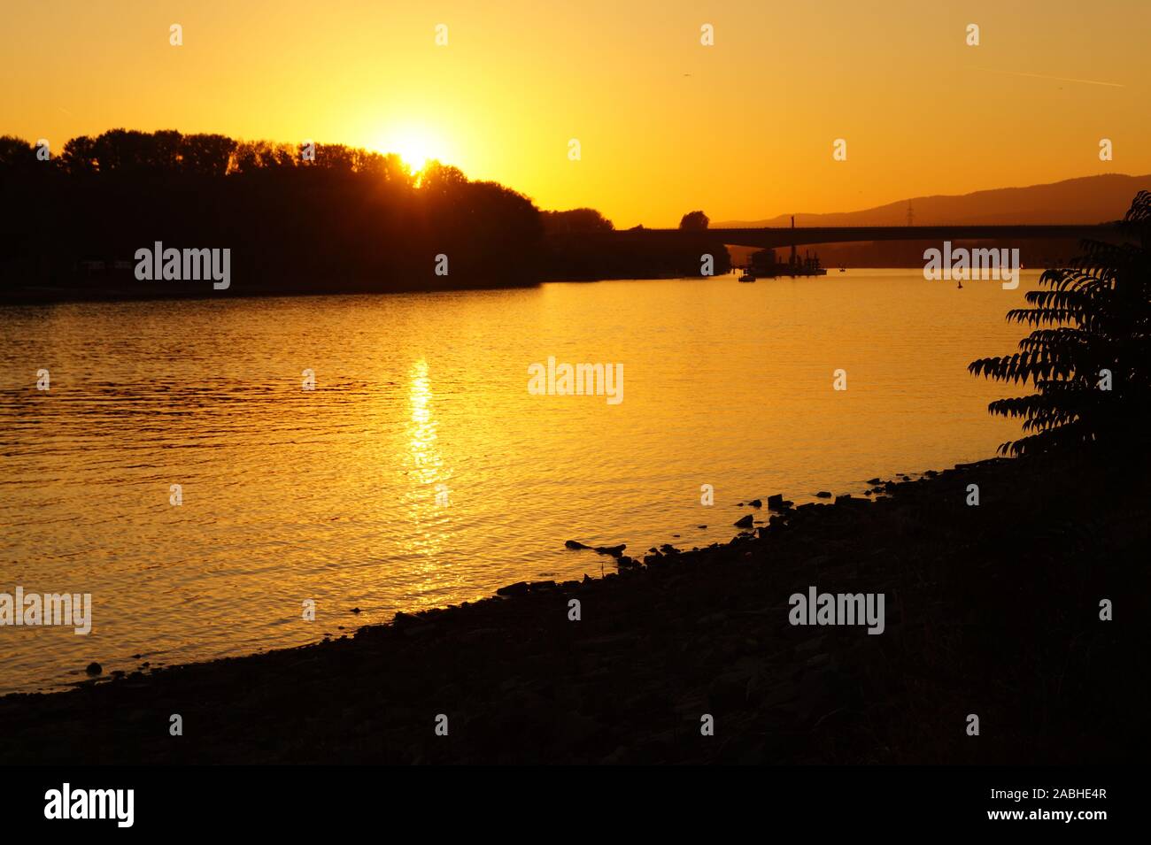 Beautiful sunset silhouette at a river Stock Photo - Alamy