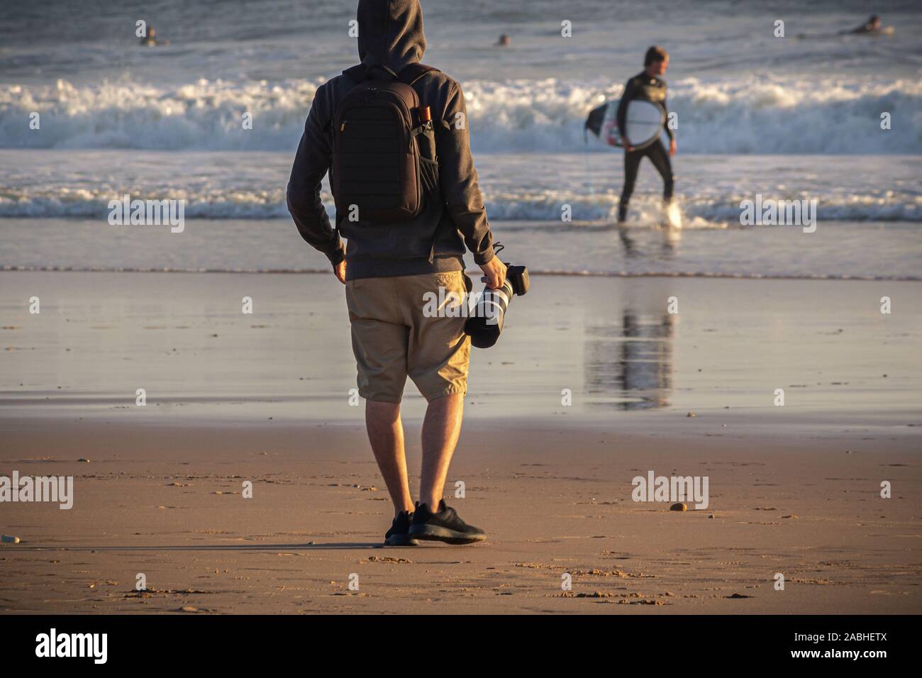 a photographer photographing surfers on the beach Stock Photo - Alamy