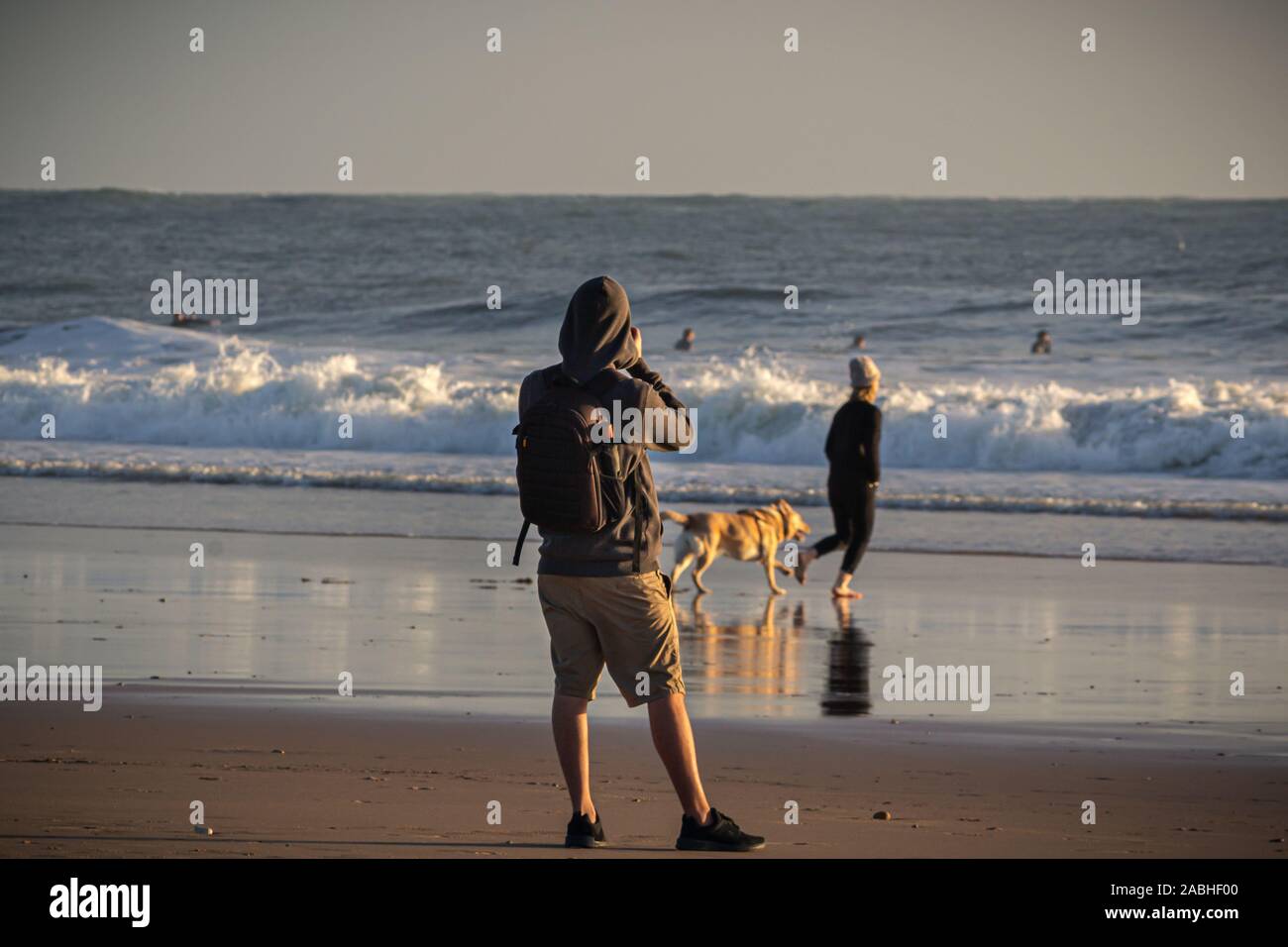 a photographer photographing surfers on the beach Stock Photo - Alamy