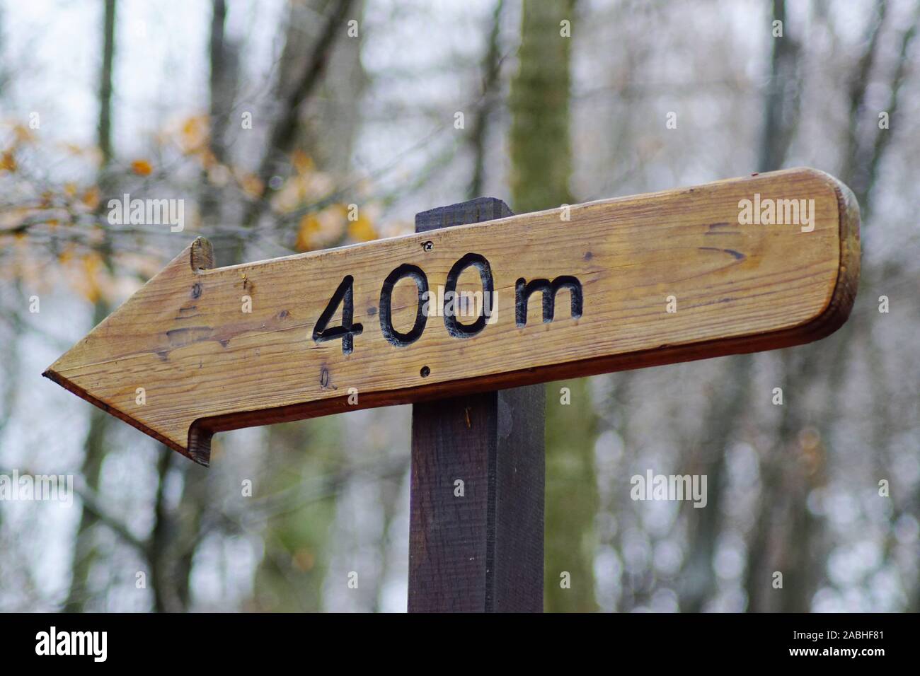 A wooden sign with the number 400 which shows the ways by meters Stock ...