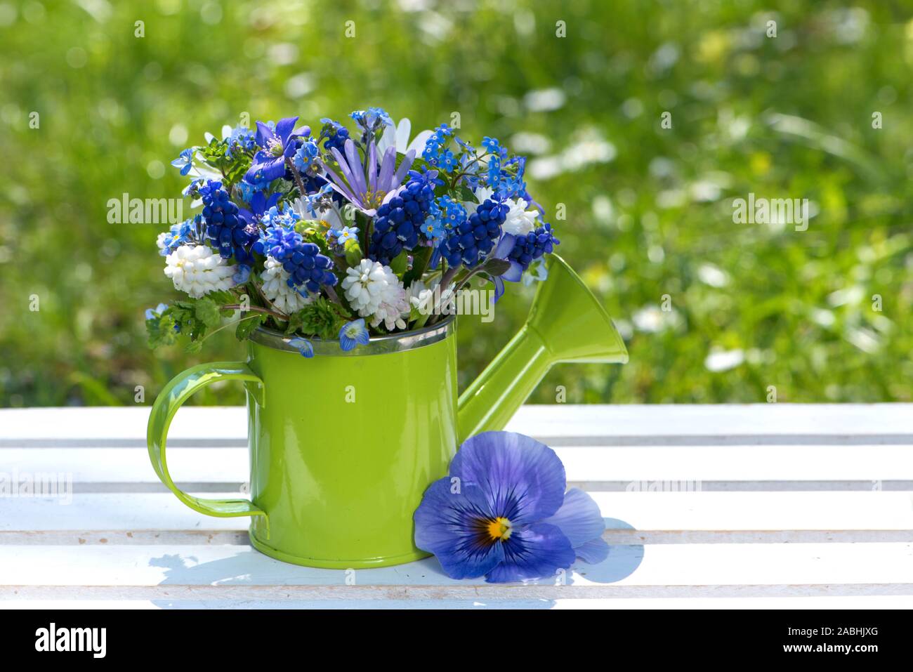 Little wild flower bouquet in a little watering can Stock Photo - Alamy