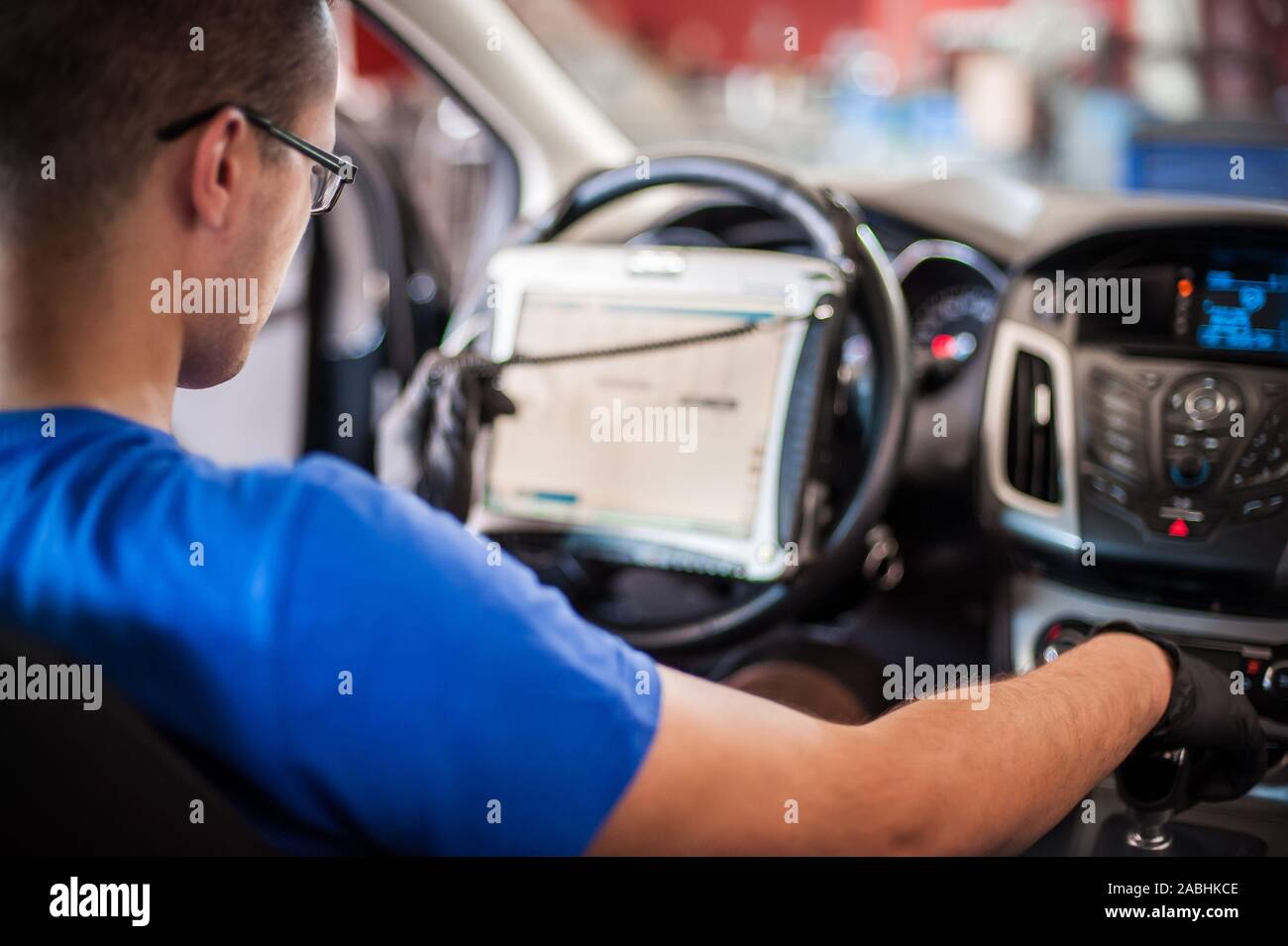 Automobile computer diagnosis. Car mechanic repairer looks for engine ...