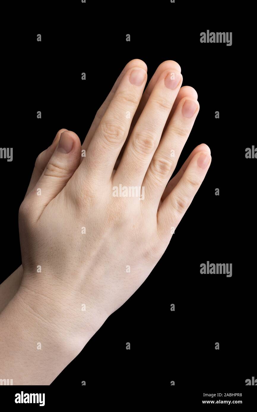 Praying hands is in the dark with light on the hands Stock Photo - Alamy