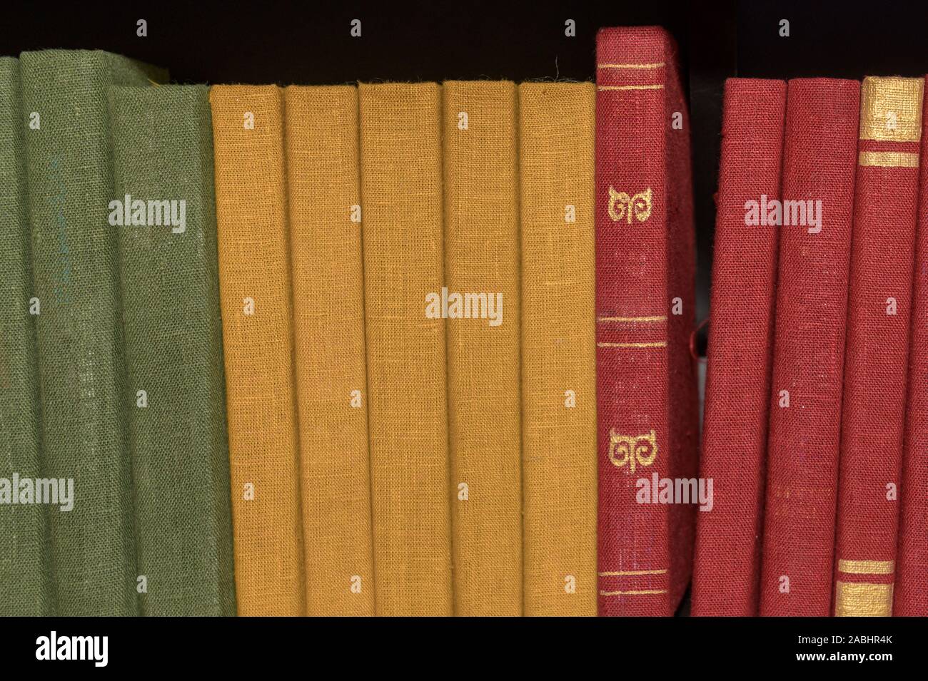 books of different colors on a bookshelf Stock Photo - Alamy