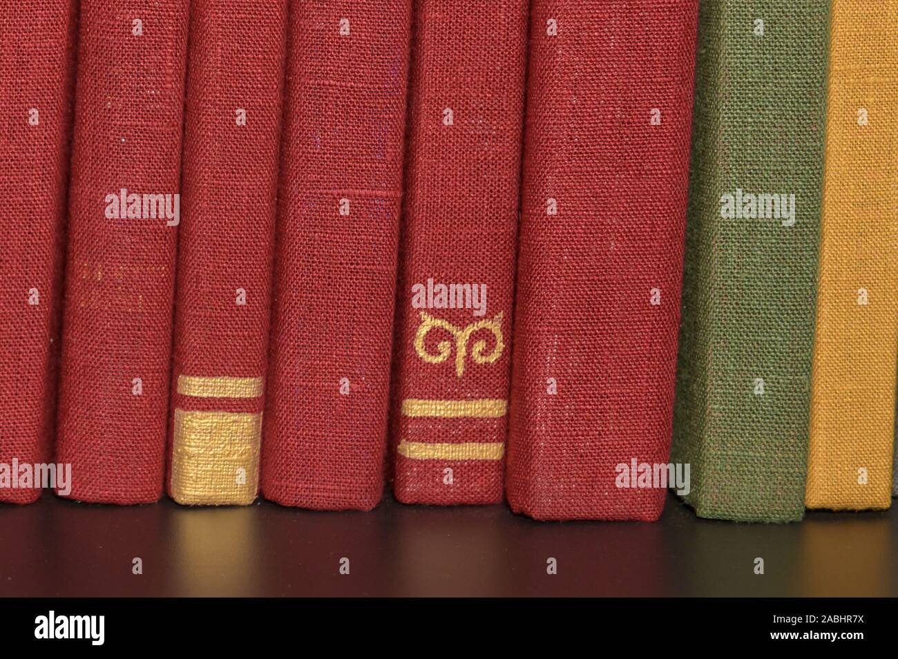 books of different colors on a bookshelf Stock Photo - Alamy
