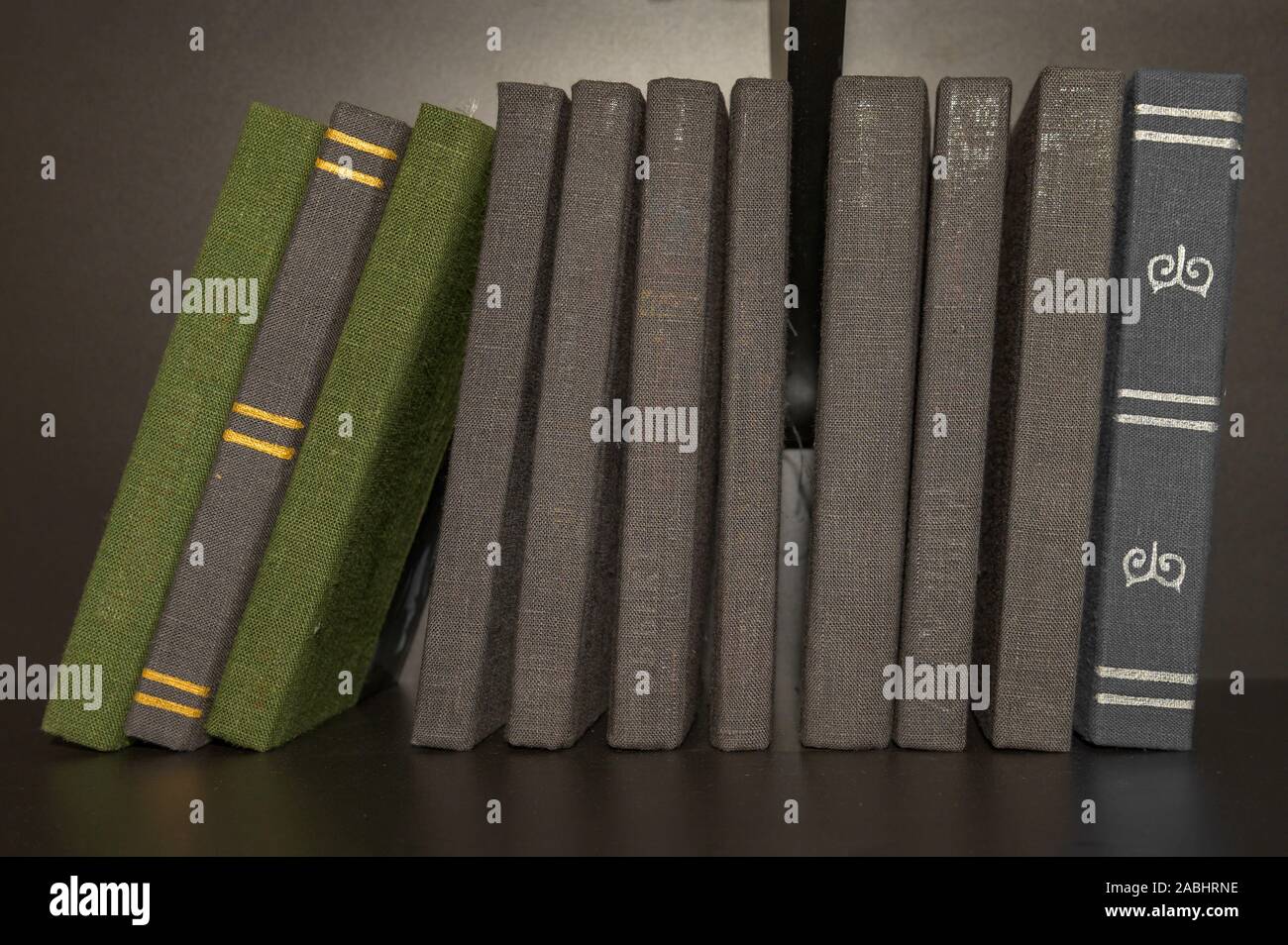 books of different colors on a bookshelf Stock Photo - Alamy