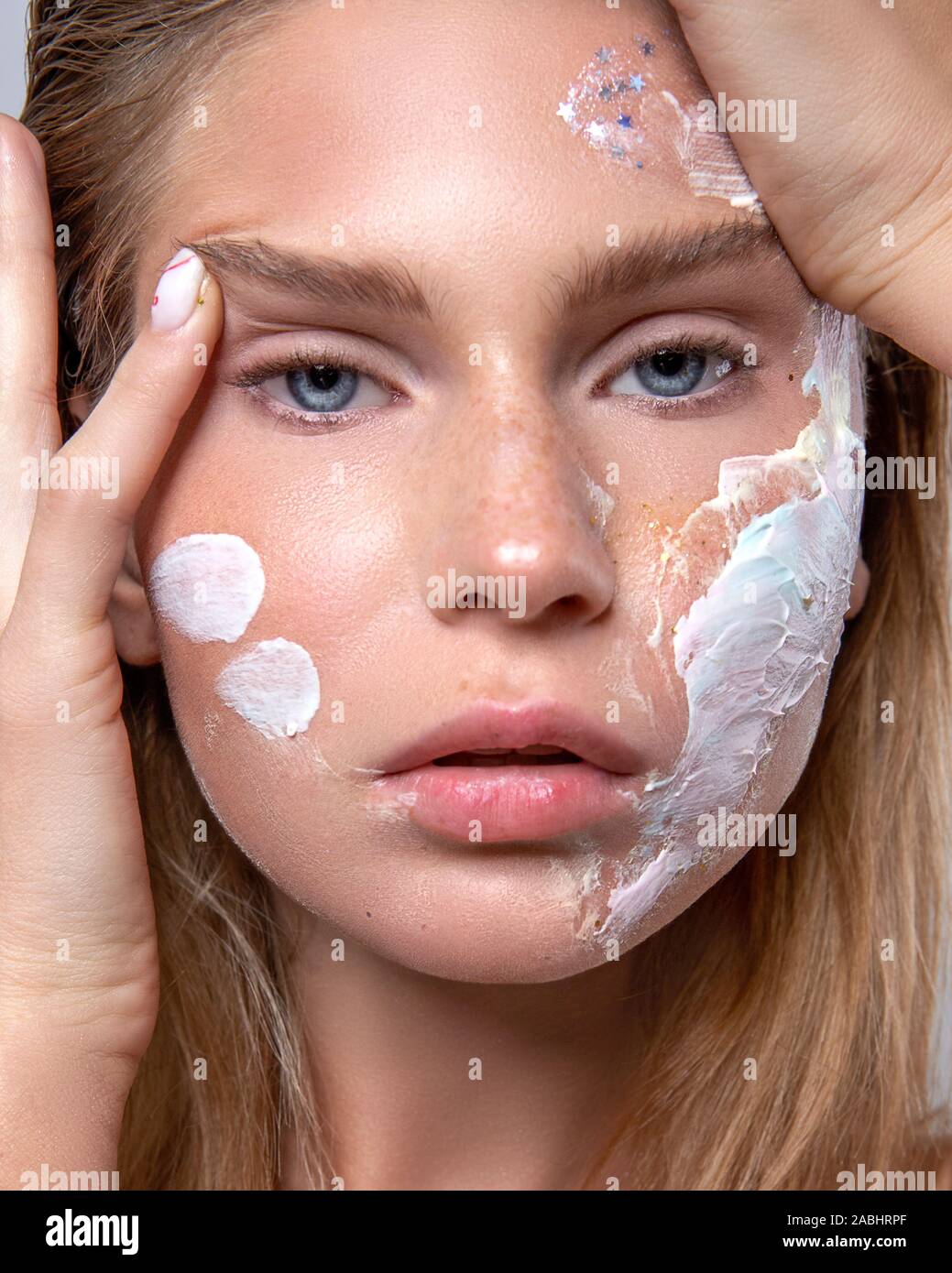 beauty portrait of a girl using skin care cosmetics Stock Photo - Alamy