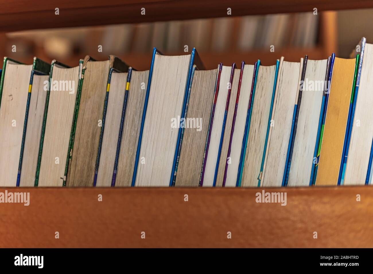 old books on a shelf in the library Stock Photo - Alamy