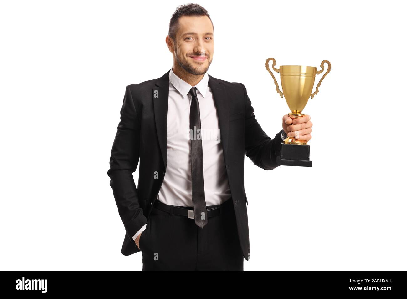 Young man in a suit and tie holding a trophy isolated on white ...