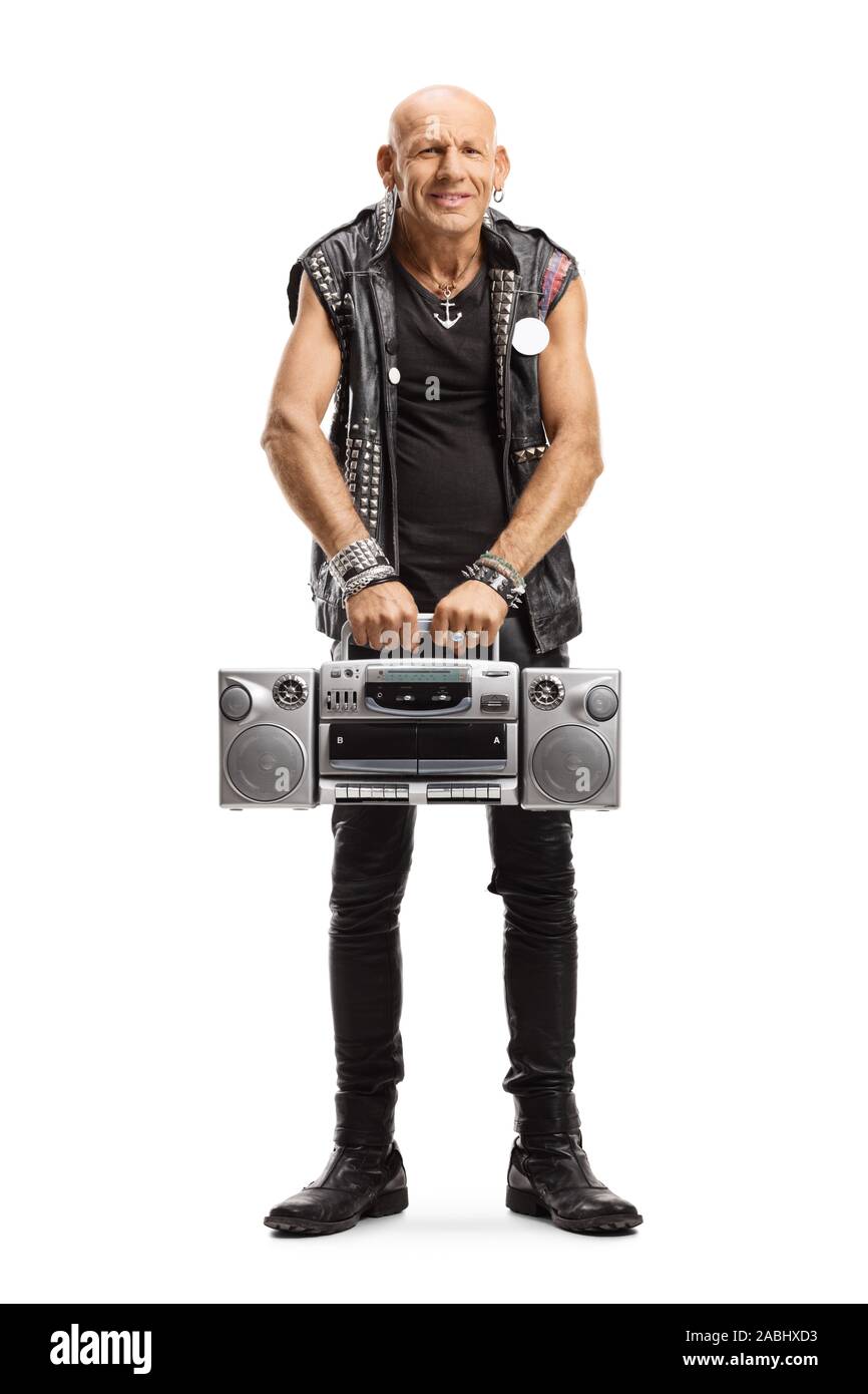 Full length portrait of a punker in leather outfit holding a boombox ...
