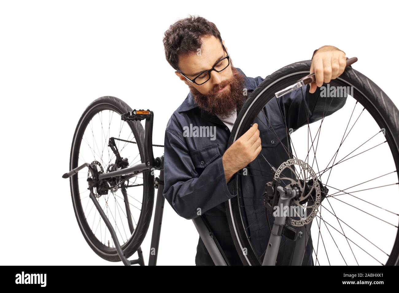 Repairman mending a bicycle isolated on white background Stock Photo ...