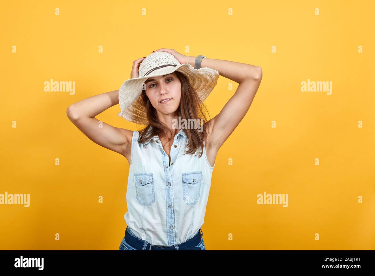 Attractive young woman holding hands over head, looking funny Stock ...