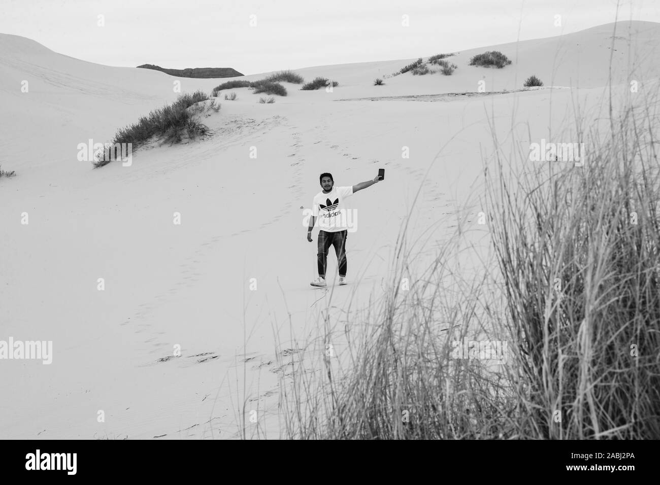 A man walks sand dunes of the Samalayuca Desert, Chihuahua Mexico. 52 ...