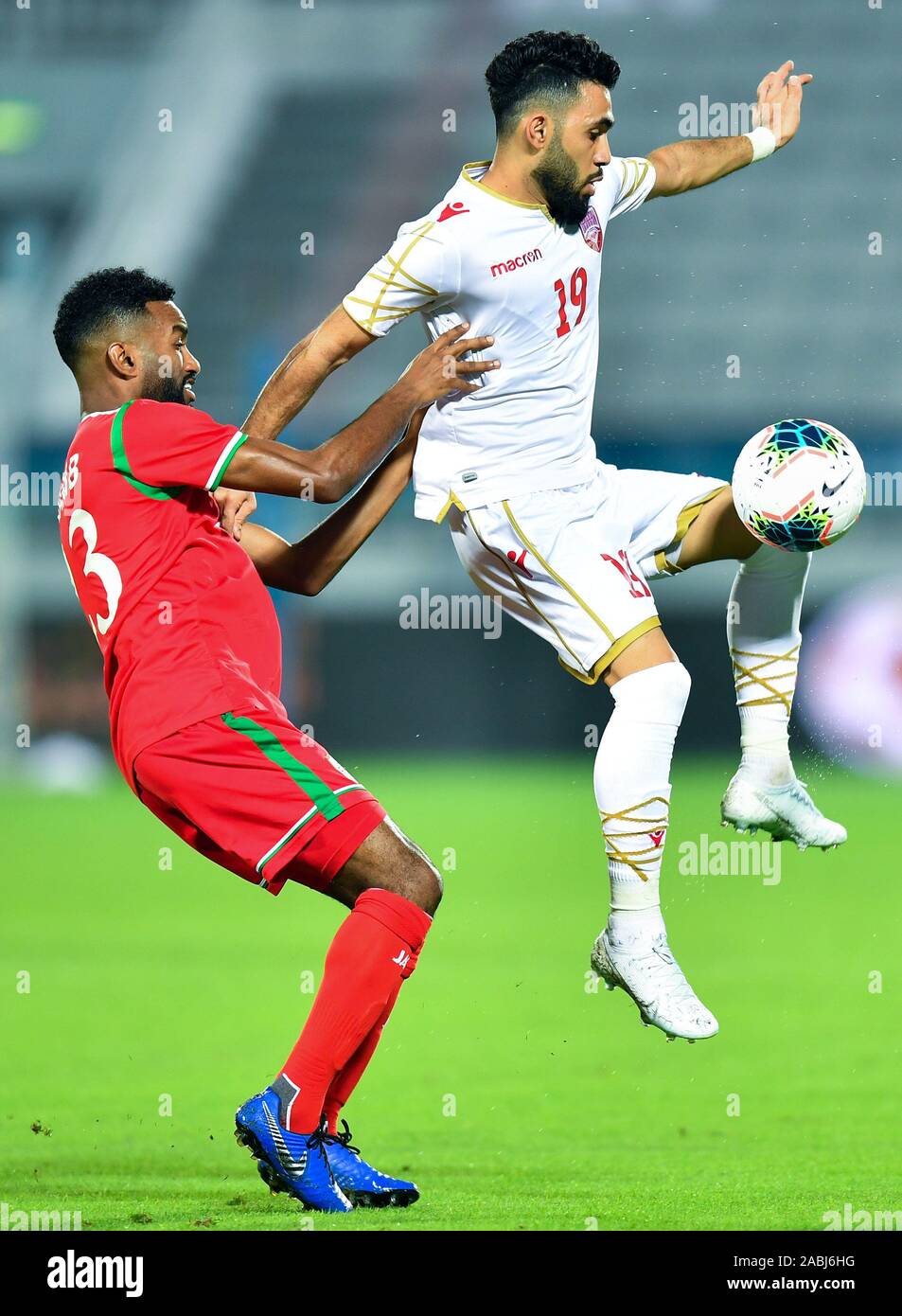 Doha, Qatar. 27th Nov, 2019. Harbi Al Saadi (L) of Oman vies with ...