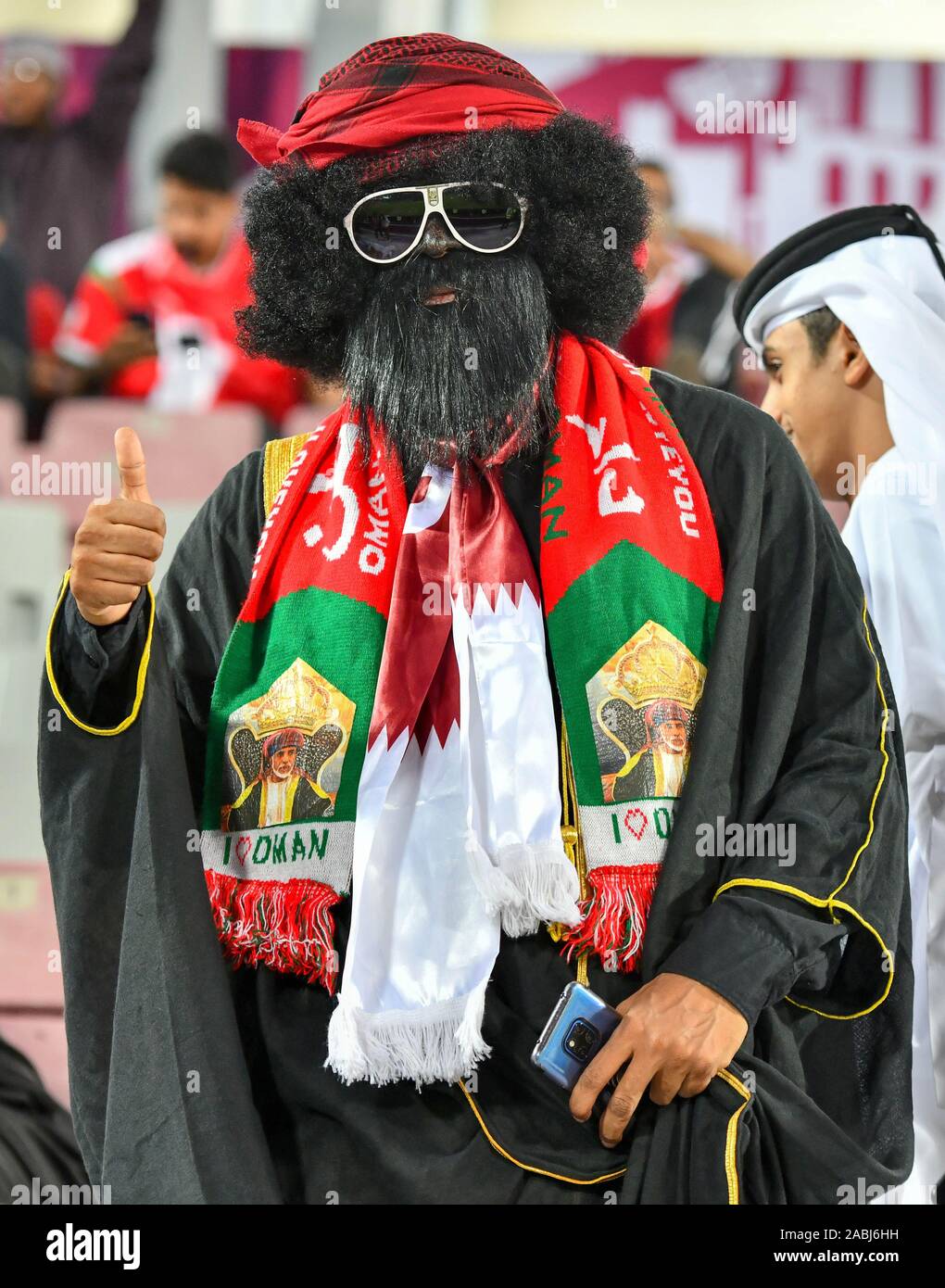 Doha, Qatar. 27th Nov, 2019. An Omani fan cheers for the team before ...