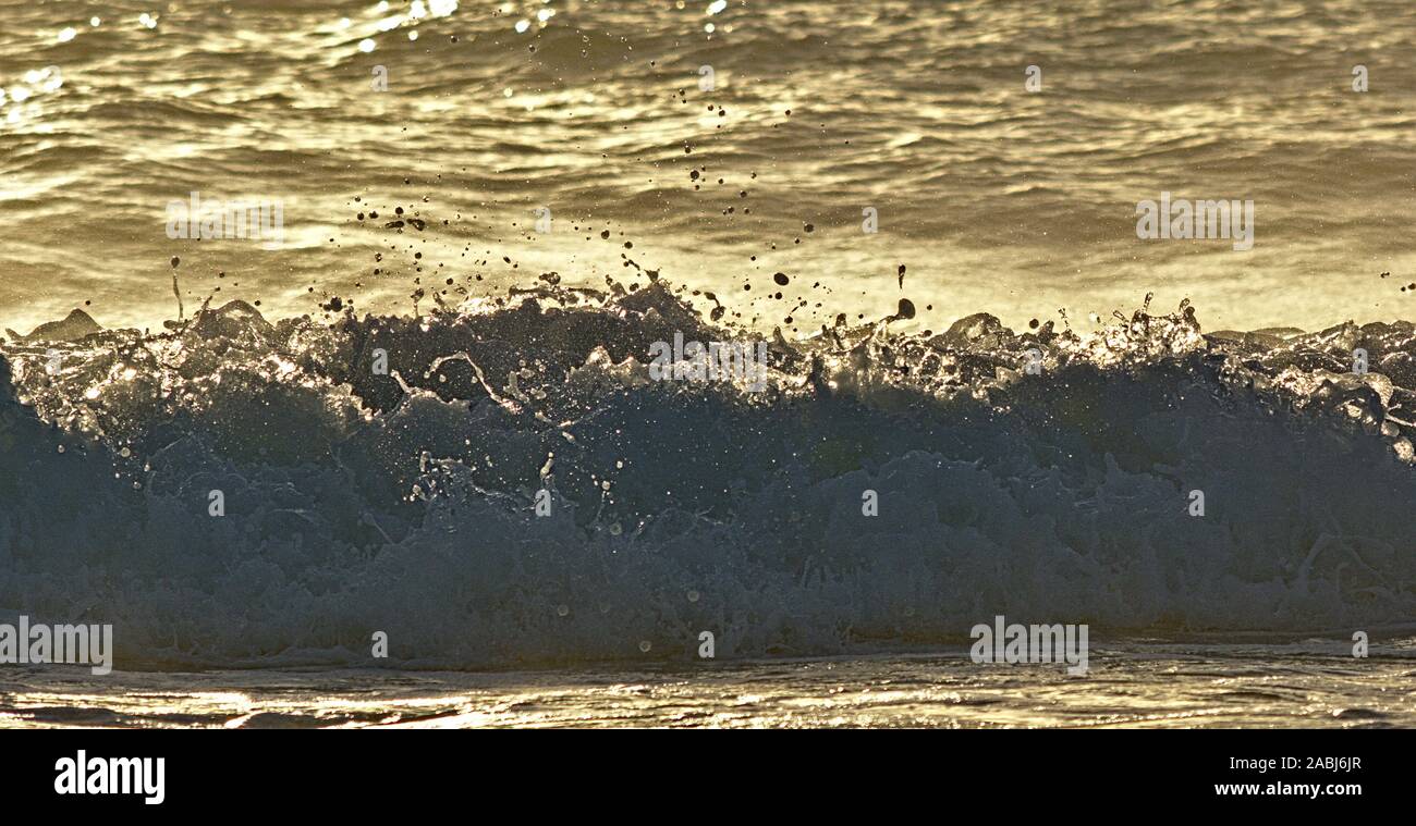 Waves splashing on sand Stock Photo - Alamy