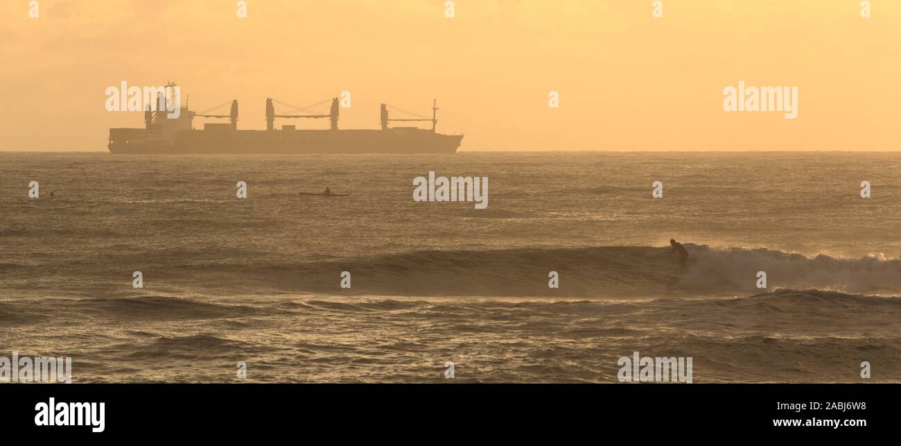 Container ship on ocean at sunrise Stock Photo - Alamy