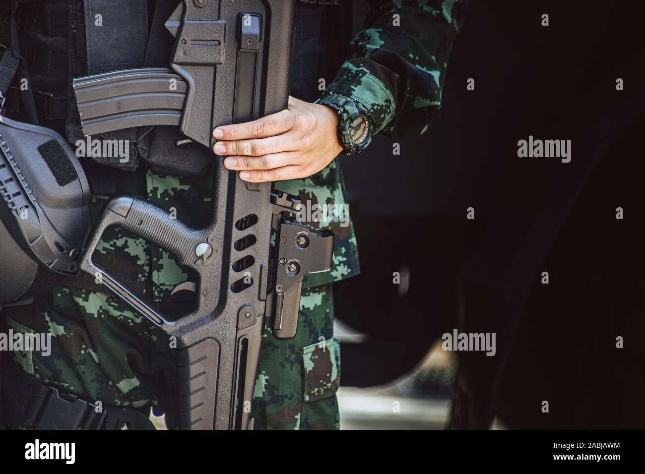 Infantry army soldier hand holding machine gun for security guard ...