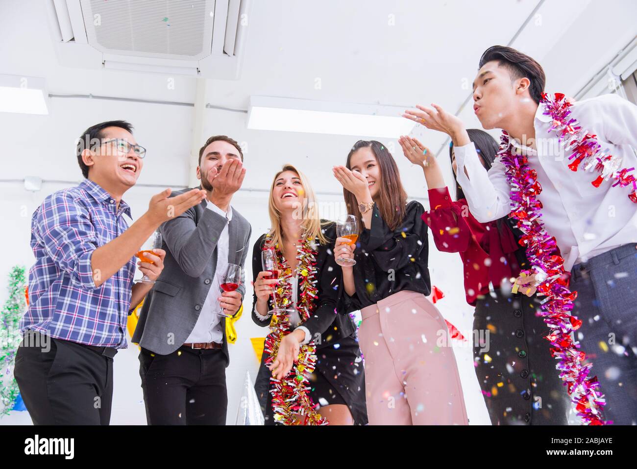 Business people blowing glitter in office party boss with staff funny ...