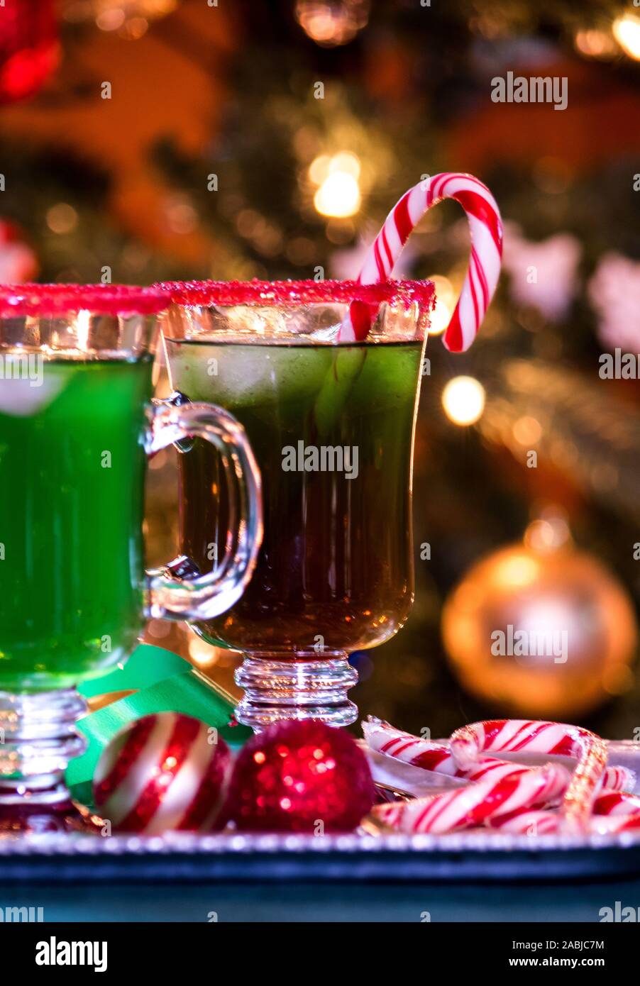 colorful Christmas cocktails garnished with red sugar rims and candy ...