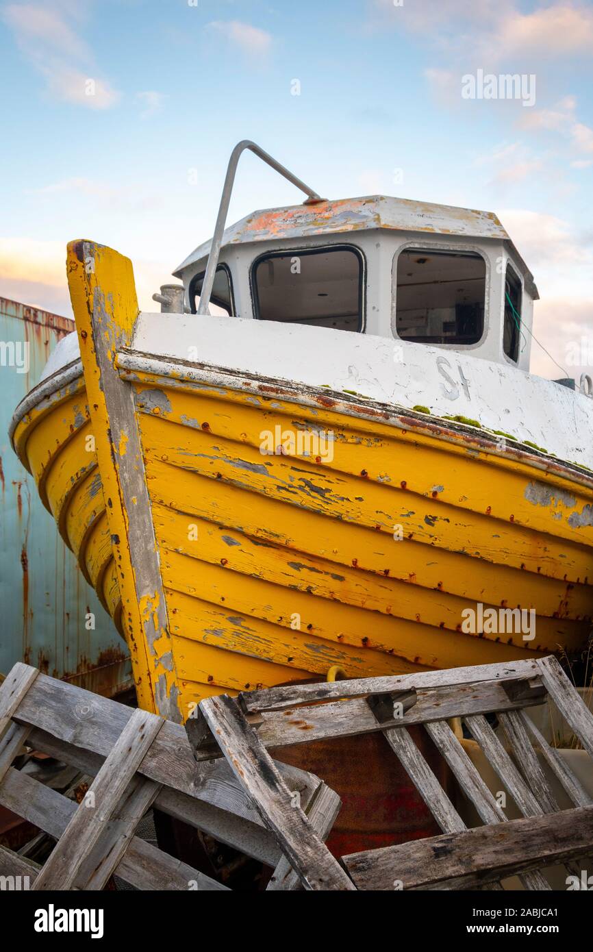 Yellow fishing boat under repair, Sudureyri, Iceland Stock Photo - Alamy