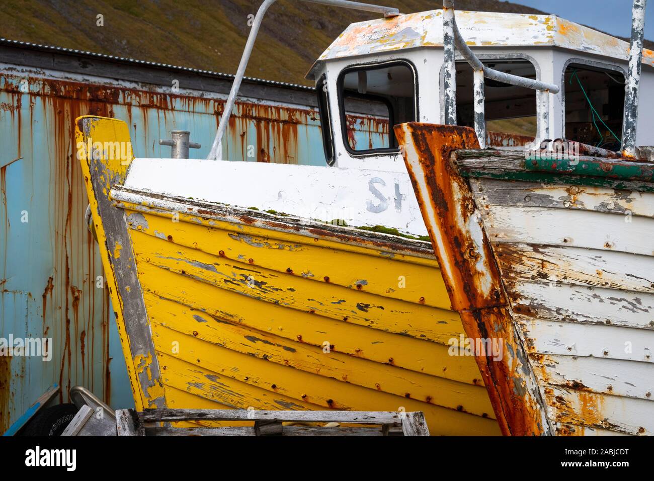 Yellow and white fishing boats under repair, Sudureyri, Iceland Stock ...