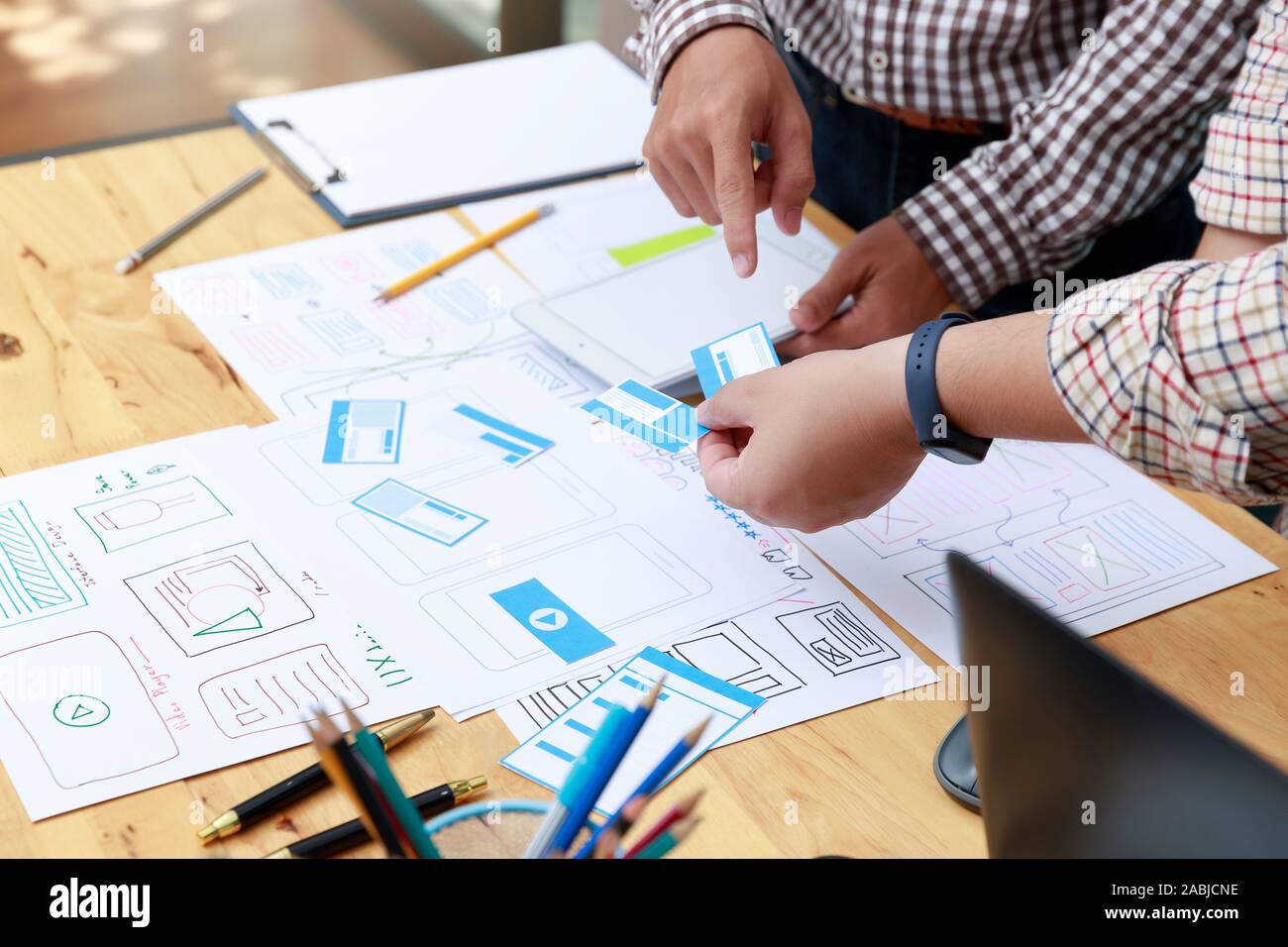 Graphic designers work together with UX UI designer planning ...
