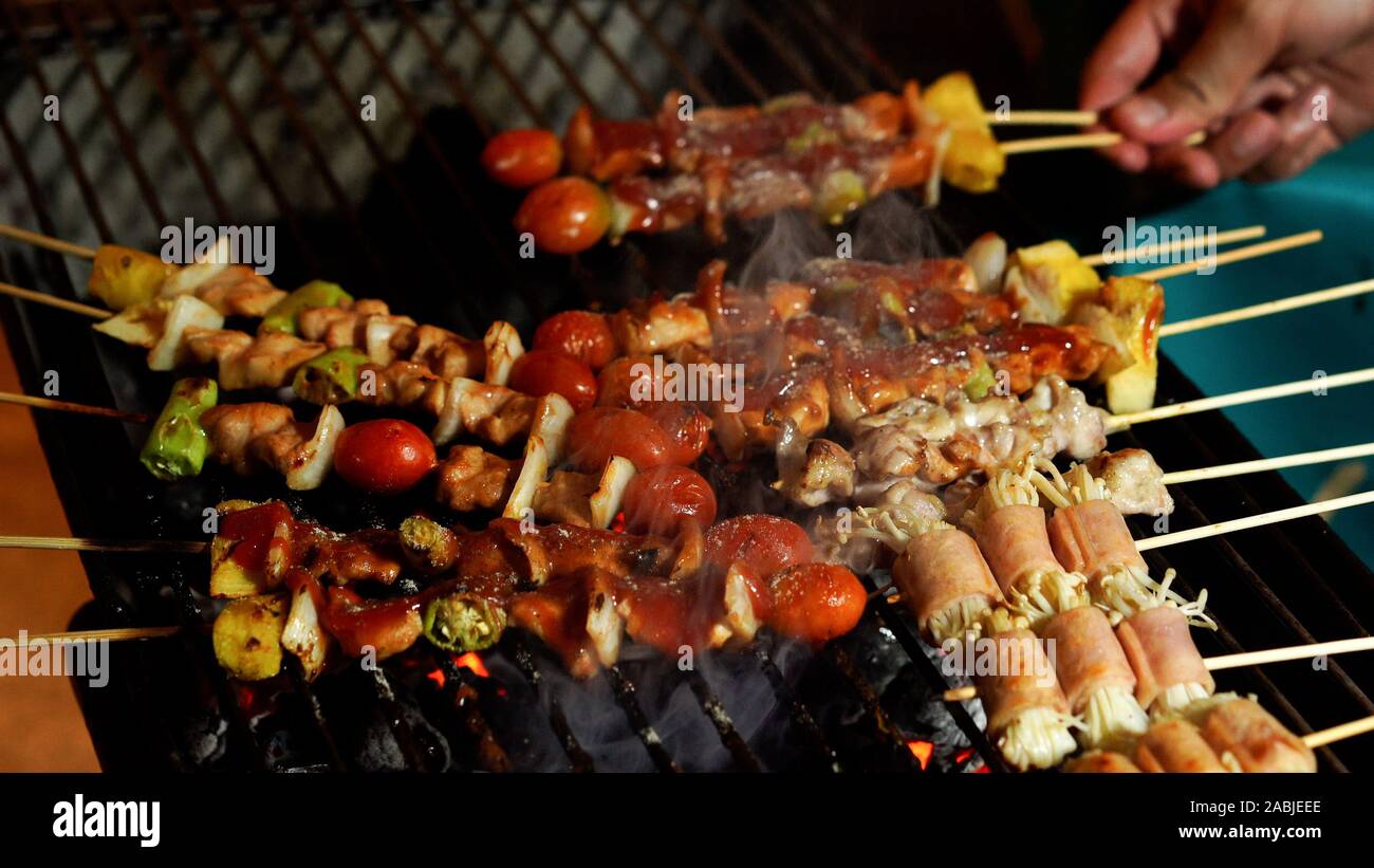 grilling barbecue pork stick in street market Stock Photo - Alamy