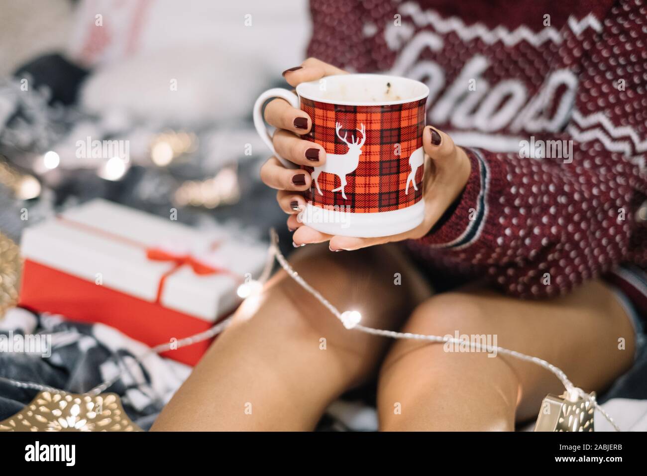 Close-up of girl warming her hands on cup Stock Photo - Alamy