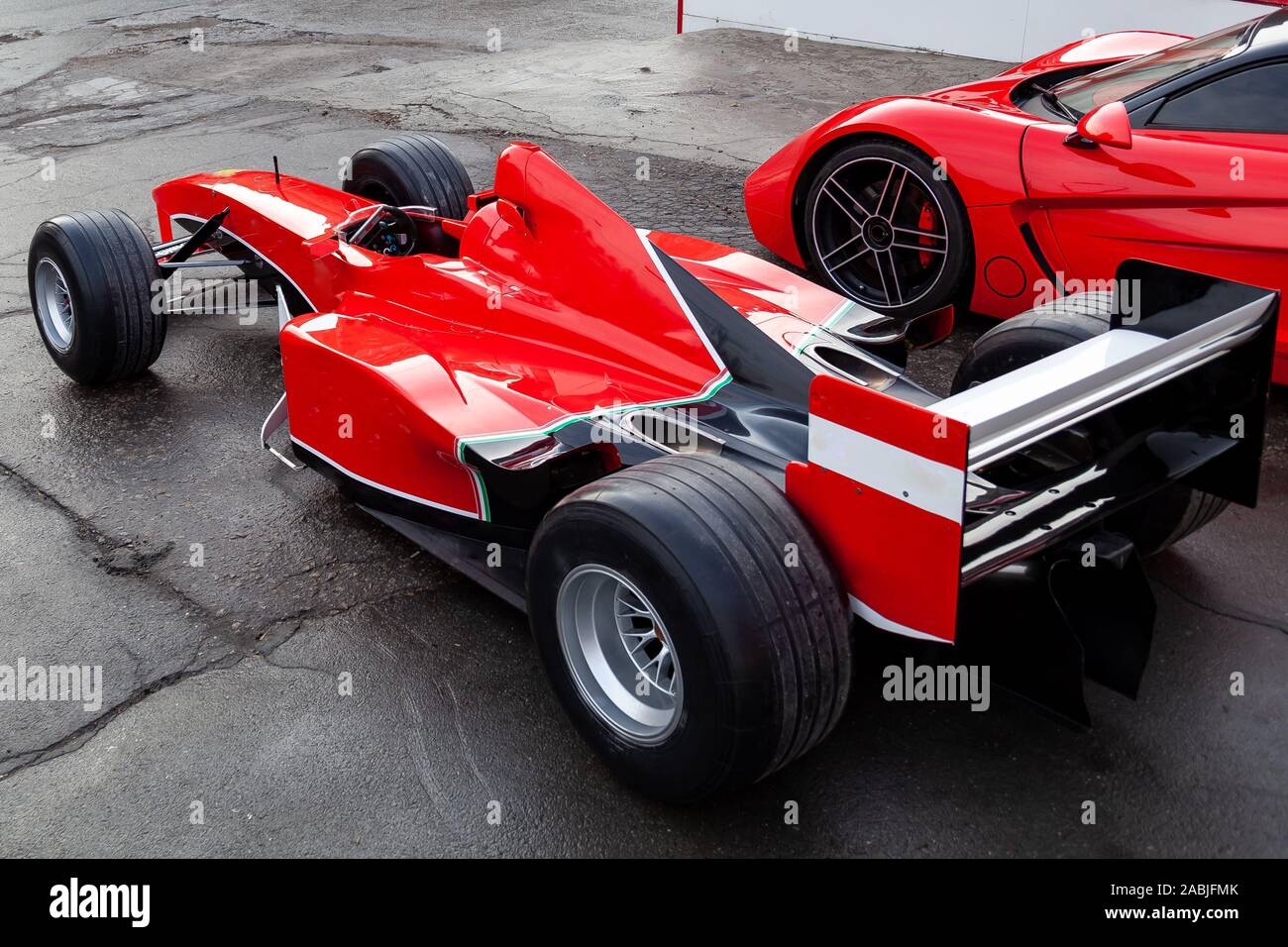Two red racing sports cars on the street near the garage box Stock ...