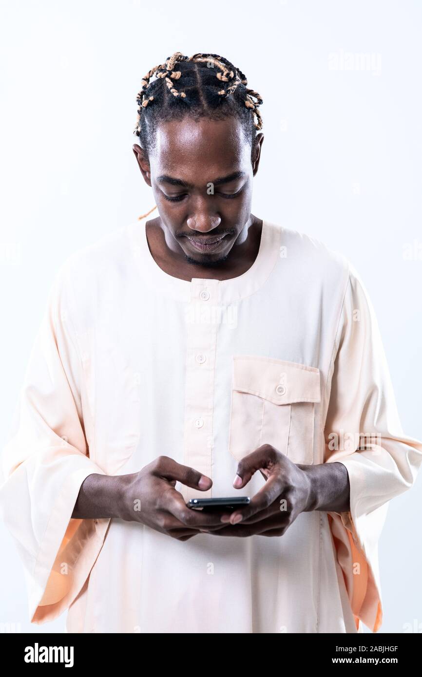 african man using smartphone and wearing traditioinal sudan clothes ...