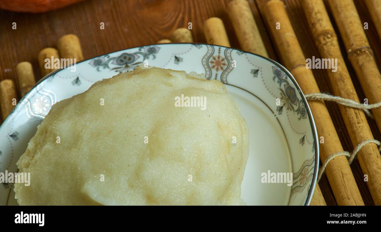 Fufu , mixing and pounding separate equal portions of cassava and green ...