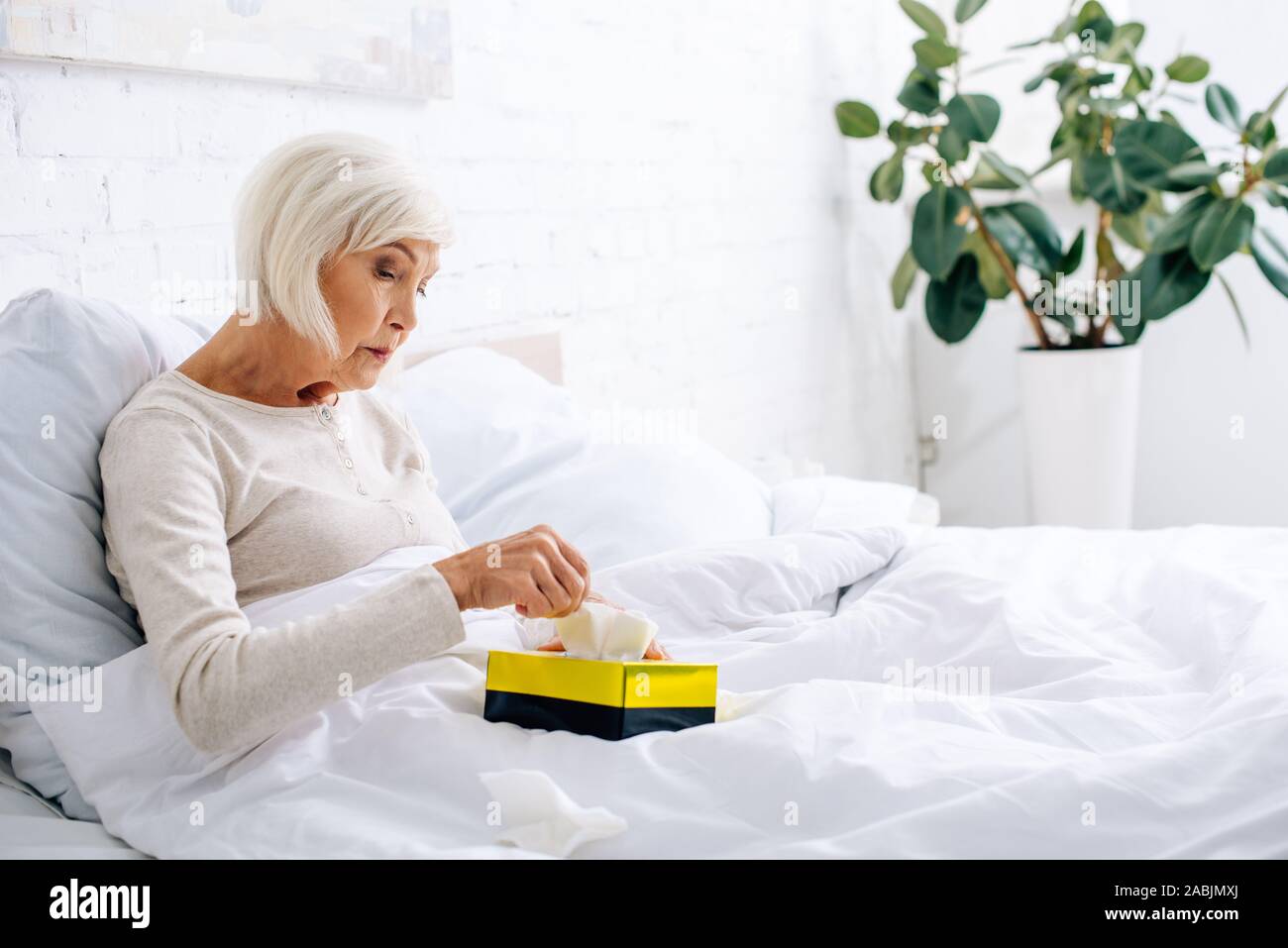 attractive and ill senior woman taking napkin in bed Stock Photo - Alamy