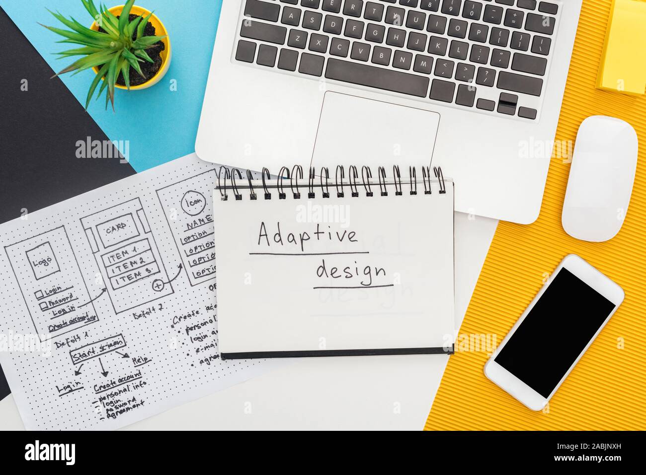 top view of website design template near notepad with adaptive design ...