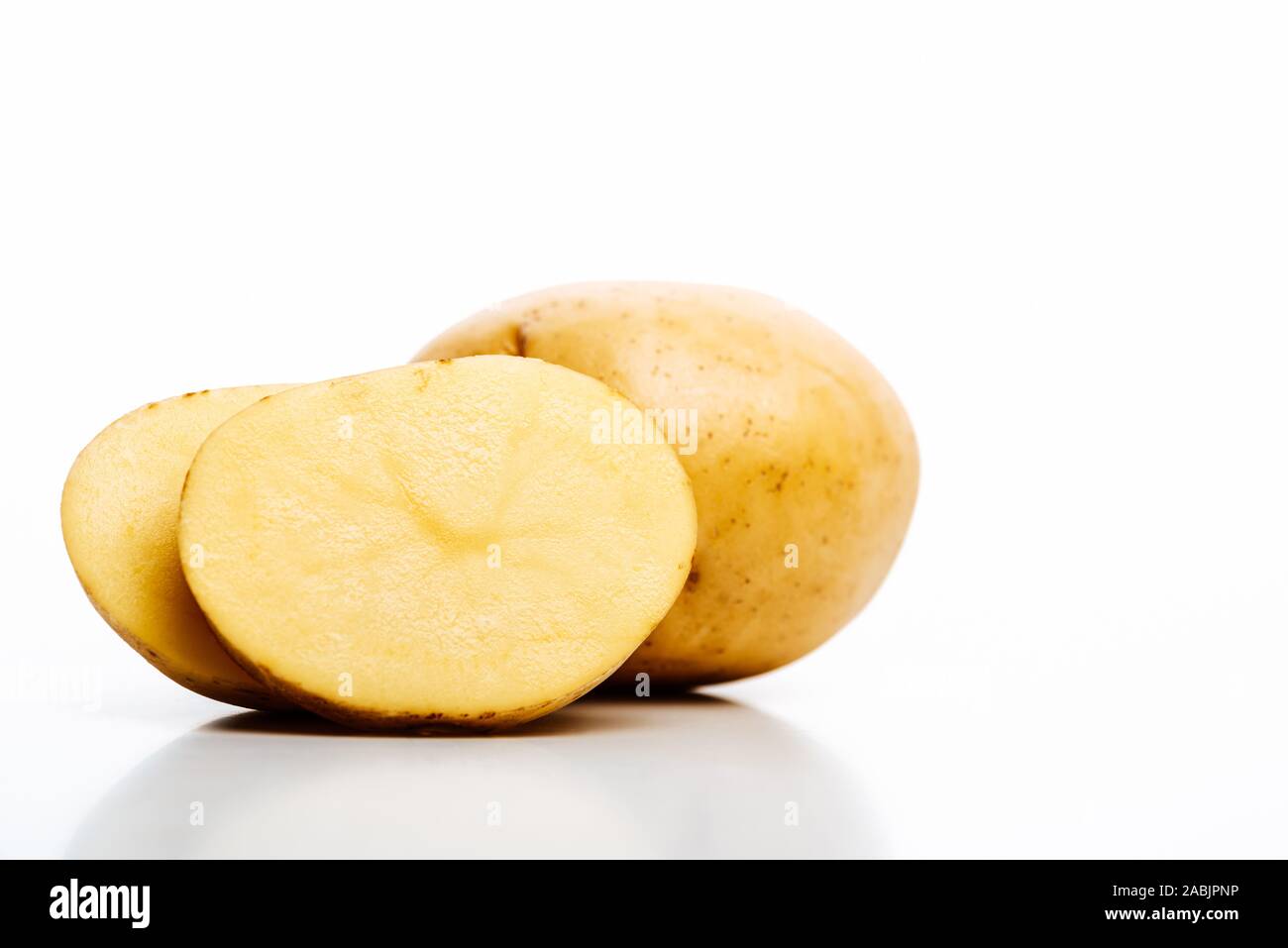 raw whole and cut fresh potatoes isolated on white Stock Photo - Alamy