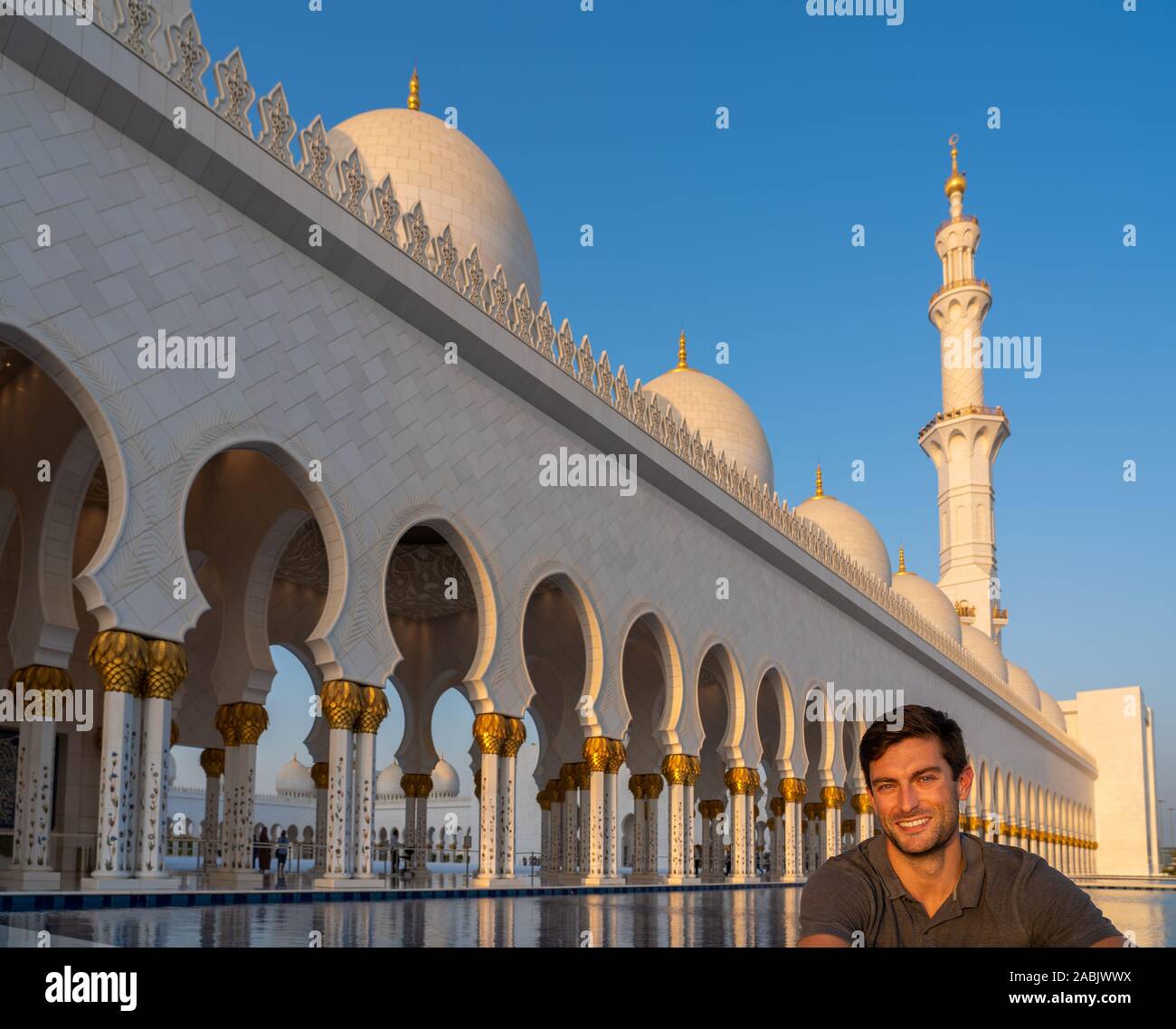 American man sitting outside the Sheikh Zayed Mosque in Abu Dhabi ...