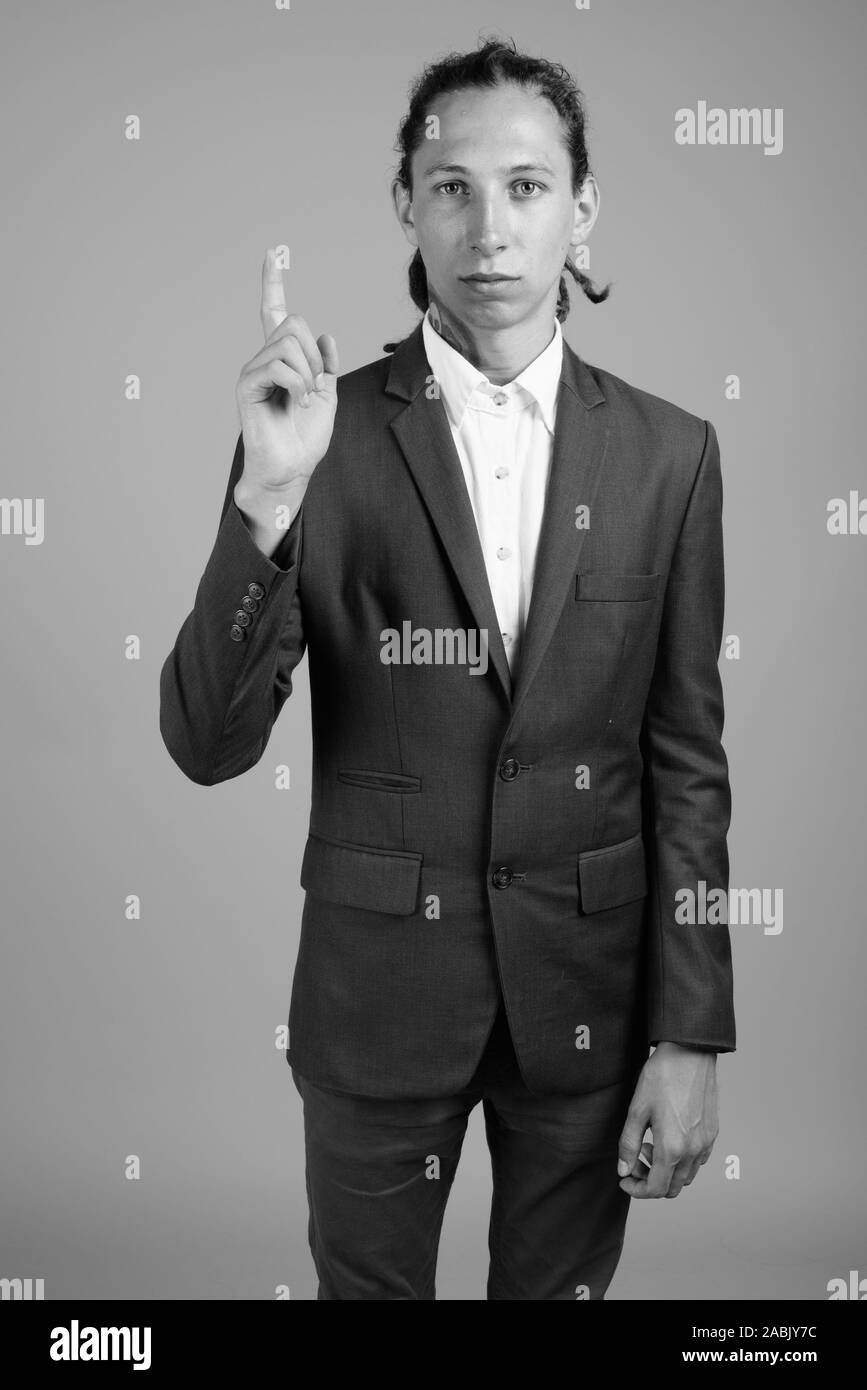 Young businessman with dreadlocks wearing suit in black and white Stock ...
